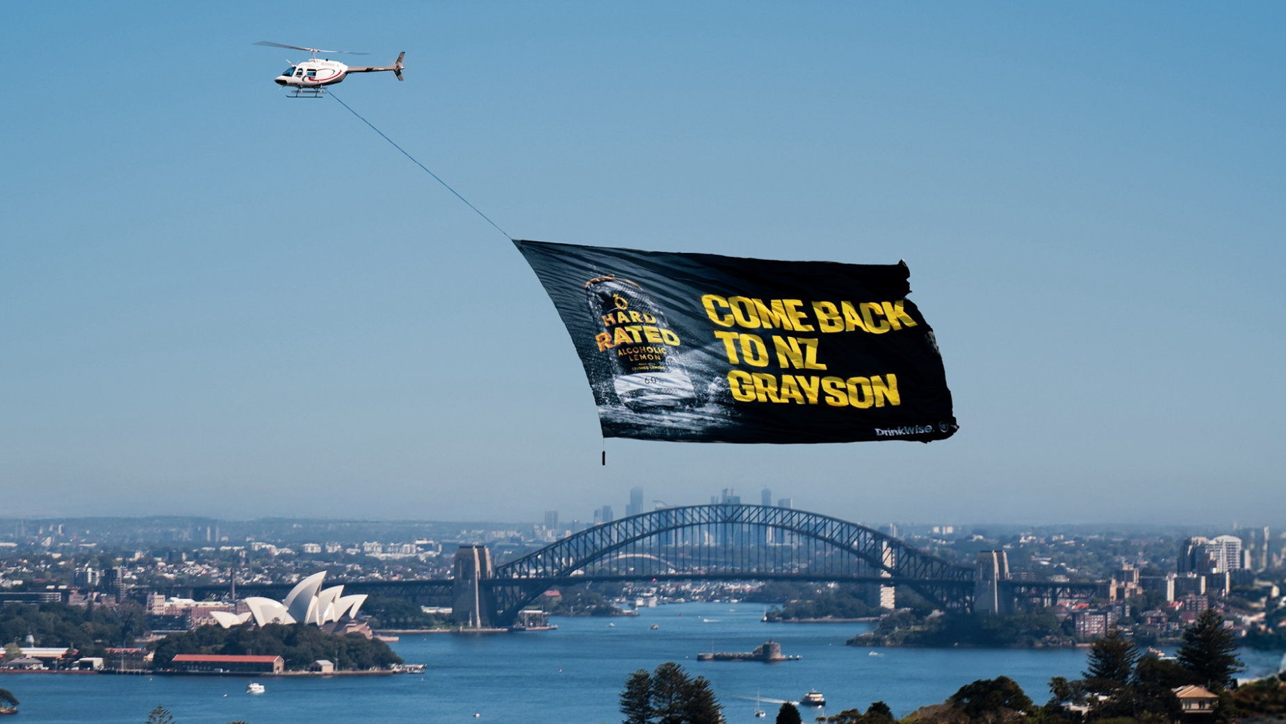 Hard Rated Flies Helicopter Banner To Convince Kiwis To Come Home ...